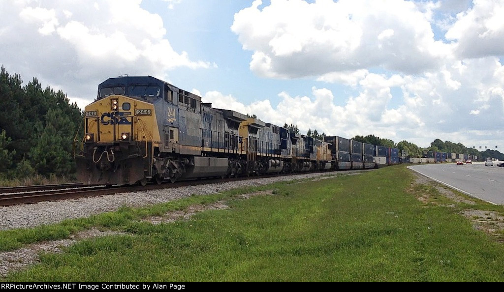 CSX AC44CW 244 leads sister-unit 279, C40-8W 7926, and UP SD70M 4294 to a stop